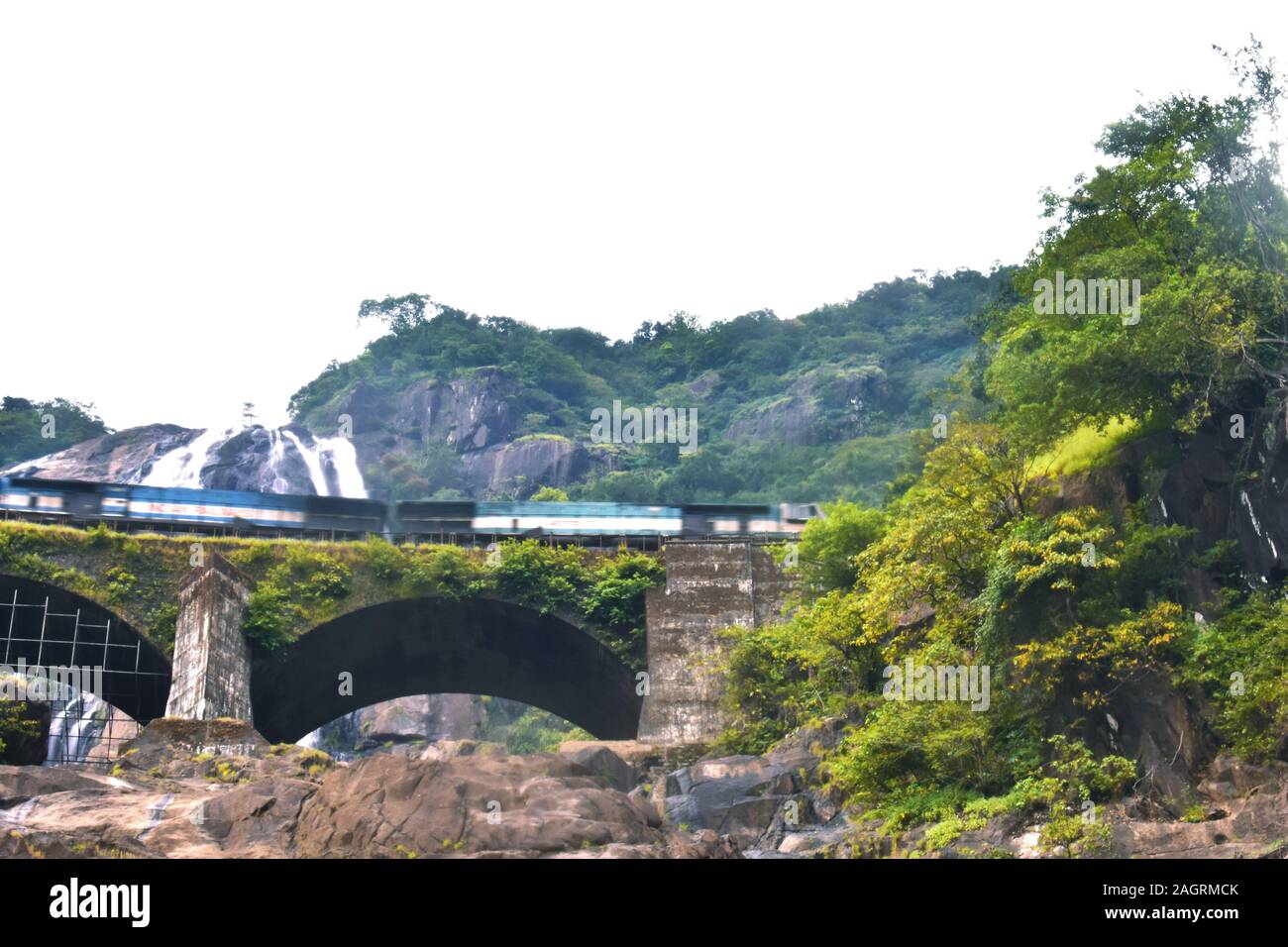 a moving train passing in front of a waterfall in goa Stock Photo - Alamy