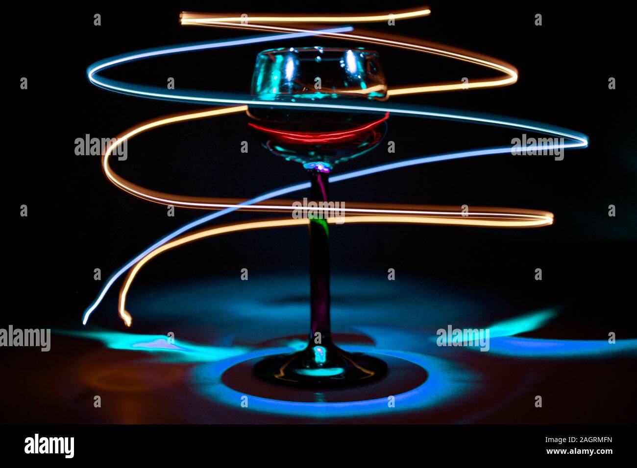A French wineglass has twisting light swirling around it Stock Photo ...