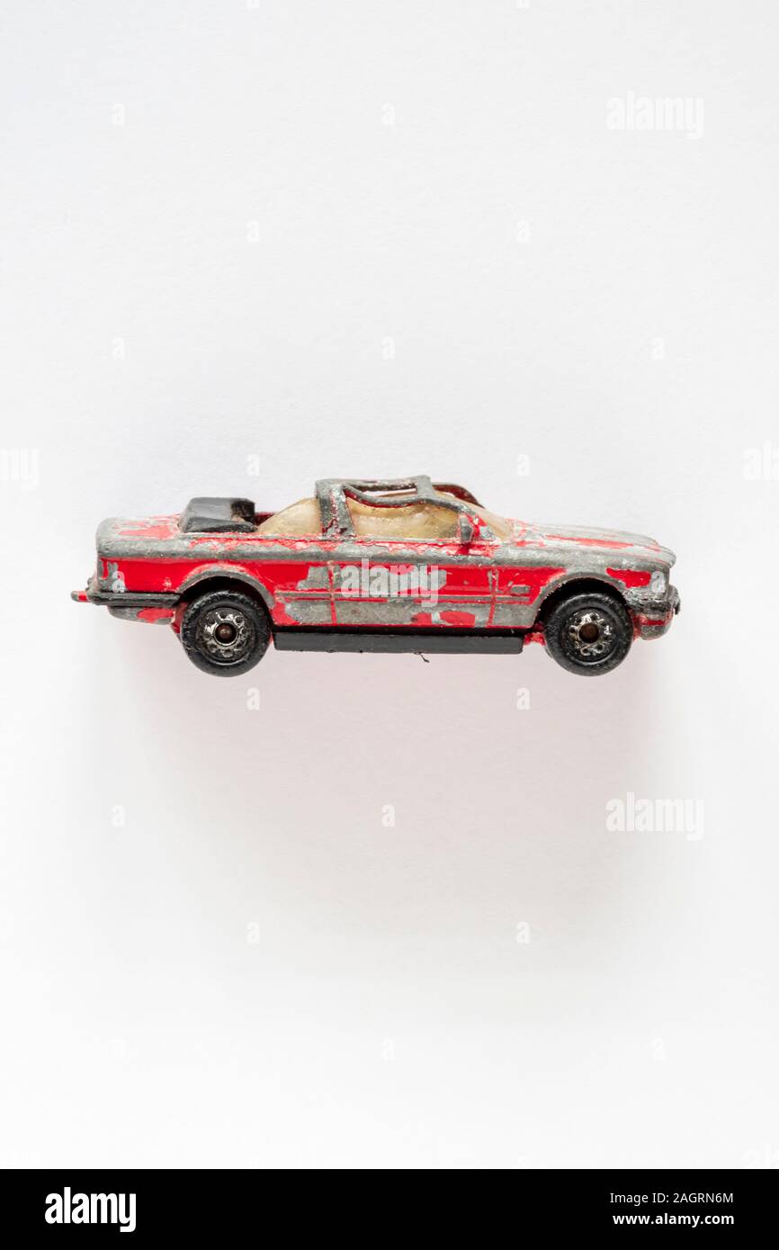 Crushed and broken die cast toy car with red paint worn off Stock Photo ...