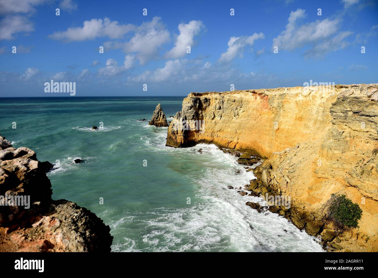 Blue tropical Caribbean seas and the high rocky cliffs of Cabo Rojo ...
