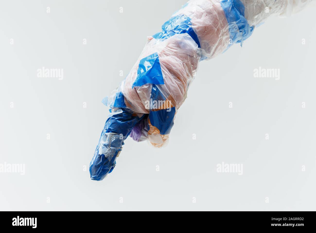 Big plastic hand made of garbage isolated on white studio background ...