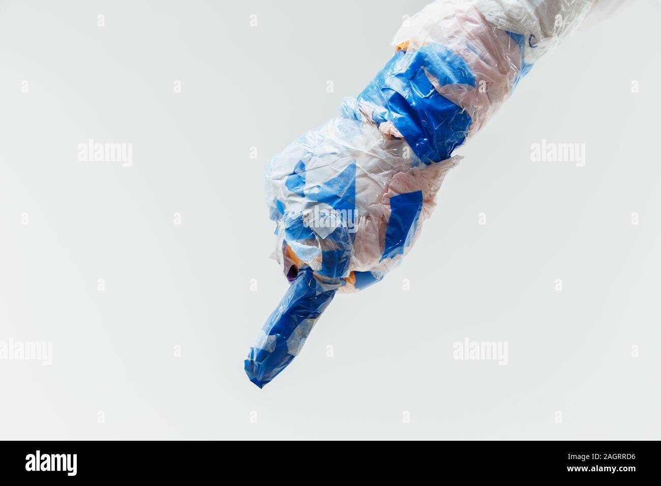 Big plastic hand made of garbage isolated on white studio background ...
