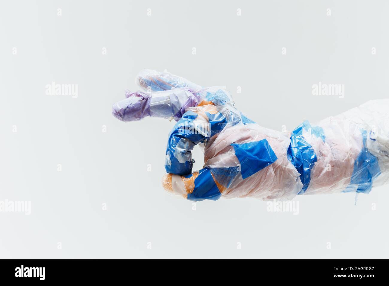 Big plastic hand made of garbage isolated on white studio background ...
