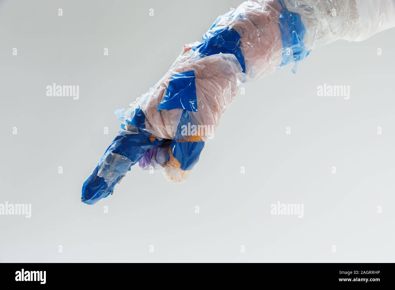 Big plastic hand made of garbage isolated on white studio background ...