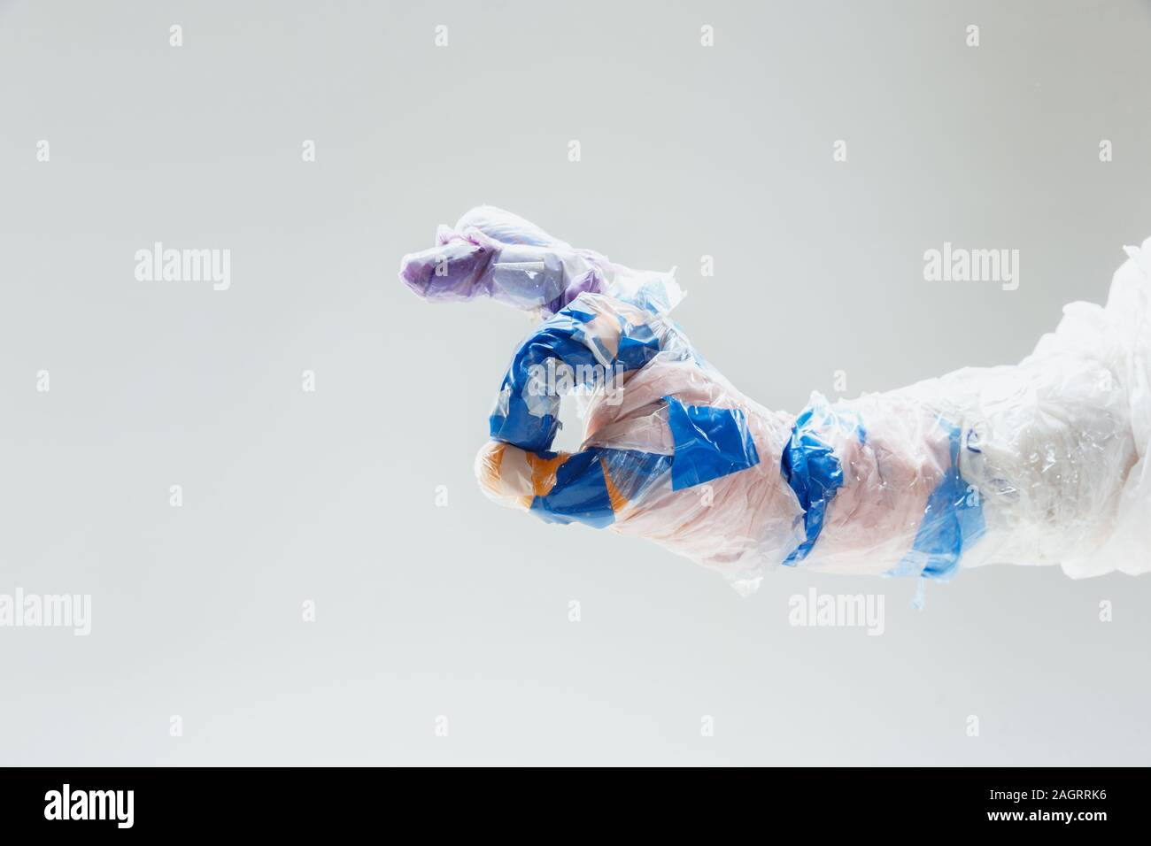 Big plastic hand made of garbage isolated on white studio background ...