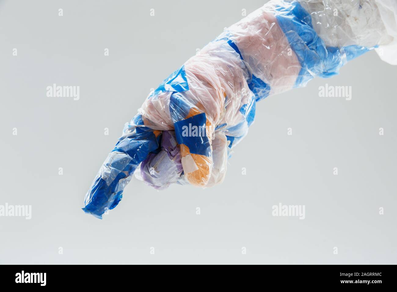 Big plastic hand made of garbage isolated on white studio background ...