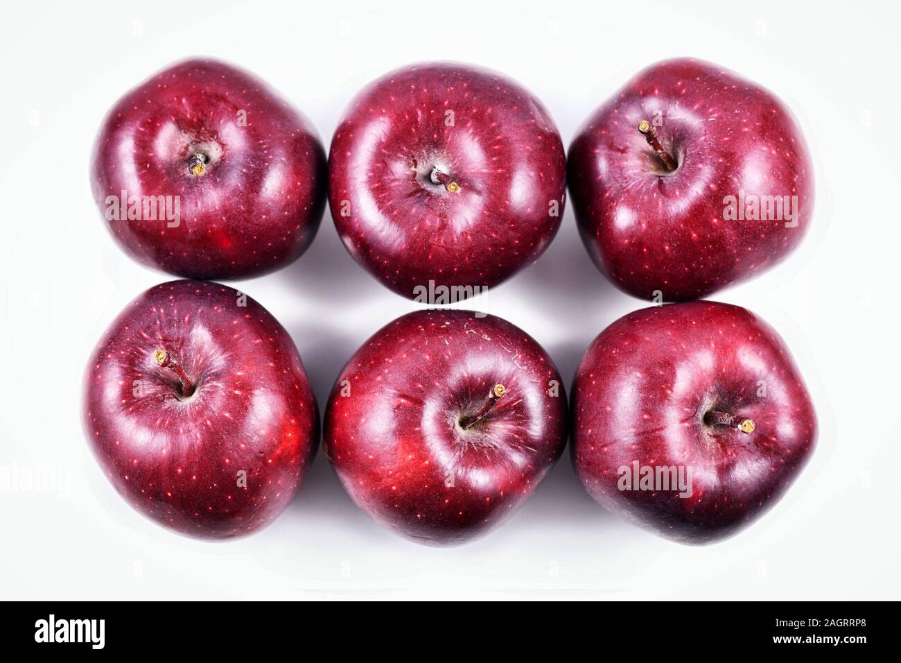 Top view of six dark red apples in rows on white background Stock Photo ...