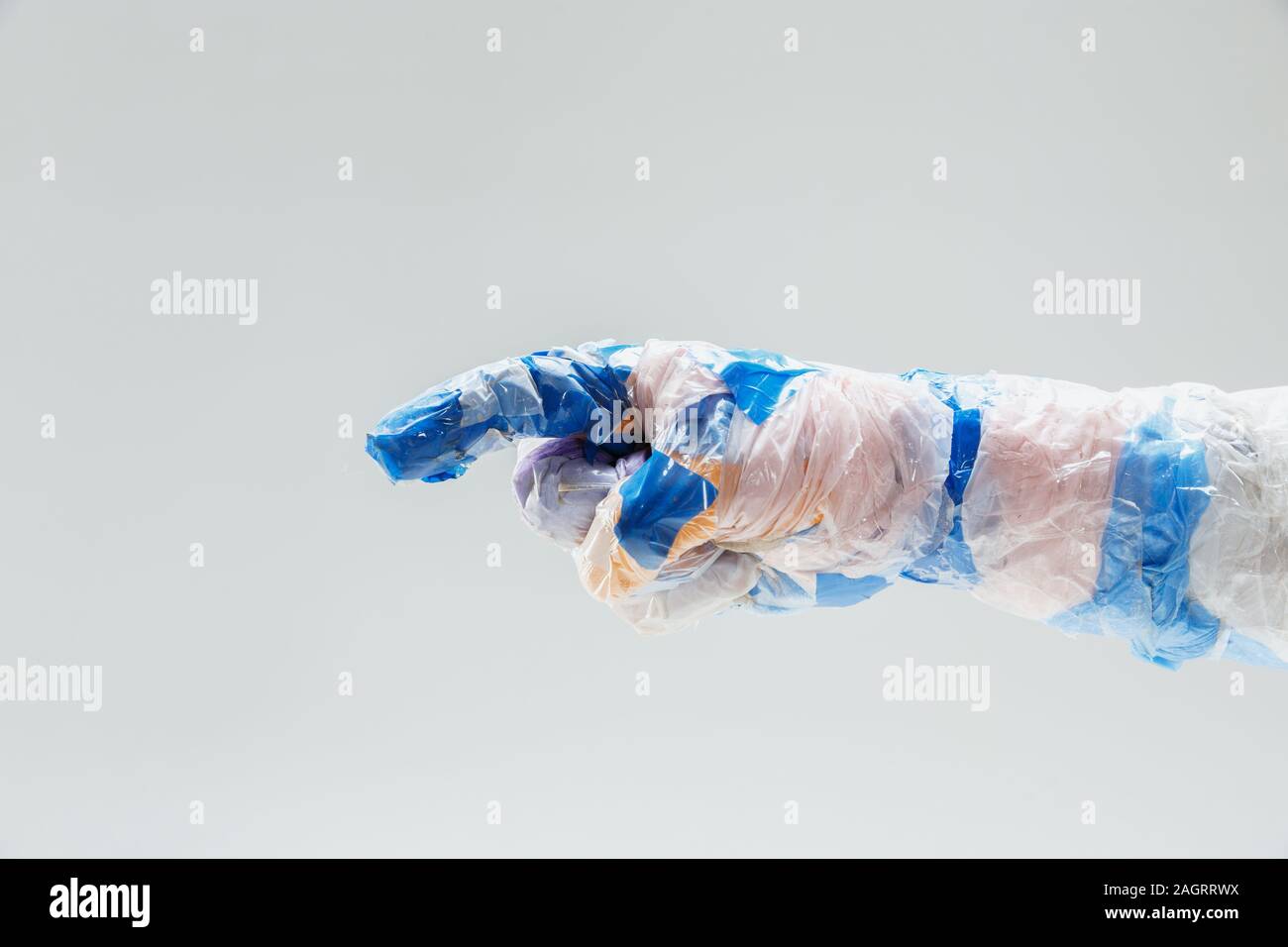 Big plastic hand made of garbage isolated on white studio background ...