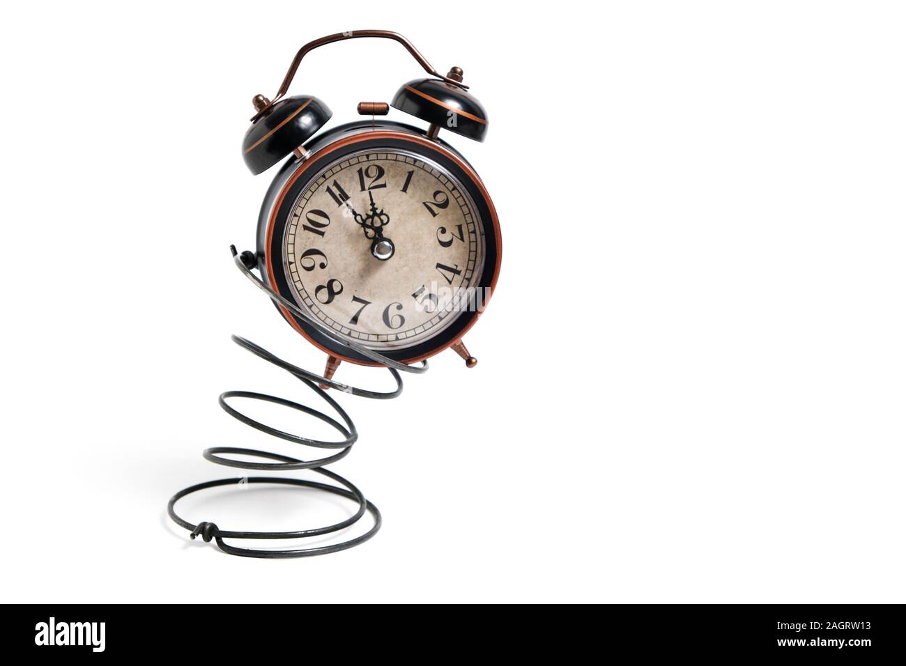 Vintage retro alarm clock Bouncing on a spring on a white background ...