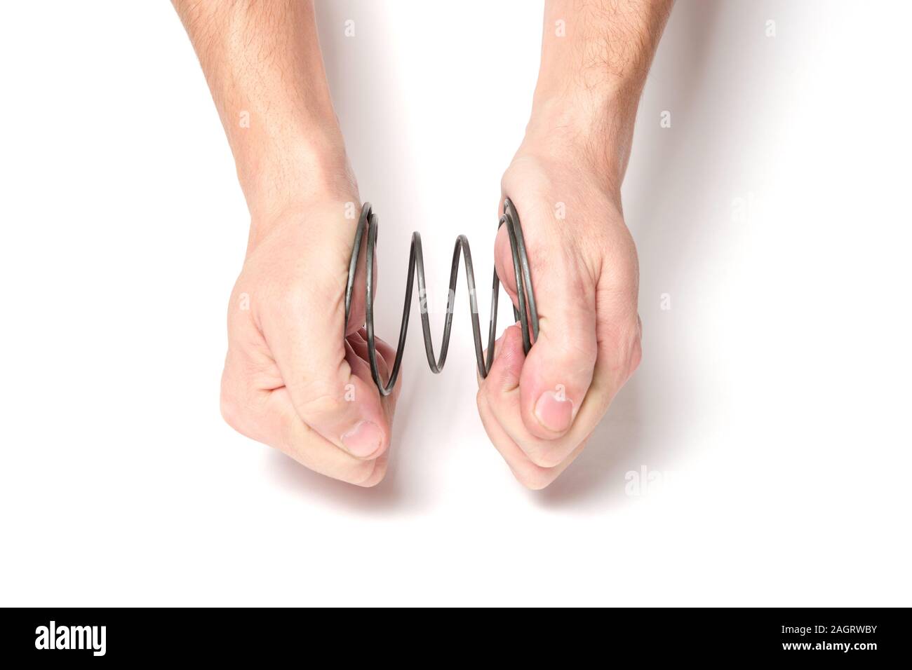 Man with two hands squeezes a spring on a white background Stock Photo ...