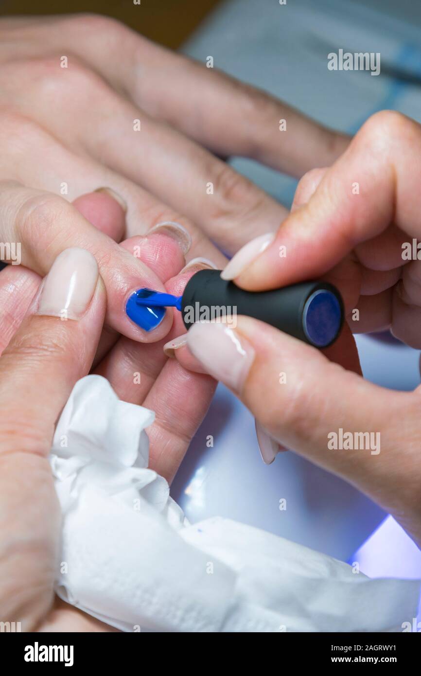 Beautiful manicure process. Nail polish being applied to hand, polish ...
