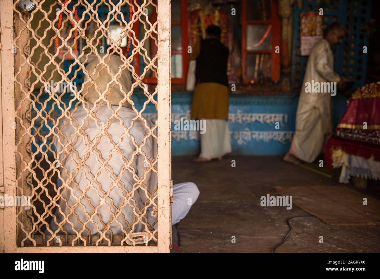 Man sitting by the door inside a small temple. Vrindavan, India Stock ...
