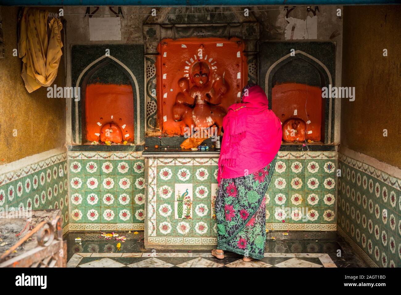 Woman making an offering at a small Hindu temple. Vrindavan Stock Photo ...