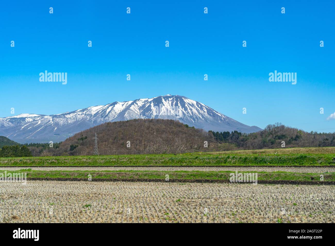 Snow capped Mount Iwate with clear blue sky natural background, beauty townscape of Takizawa and ...