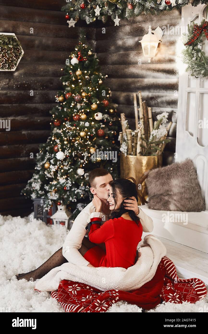 Sweet couple hugging each other on Christmas decorations background ...