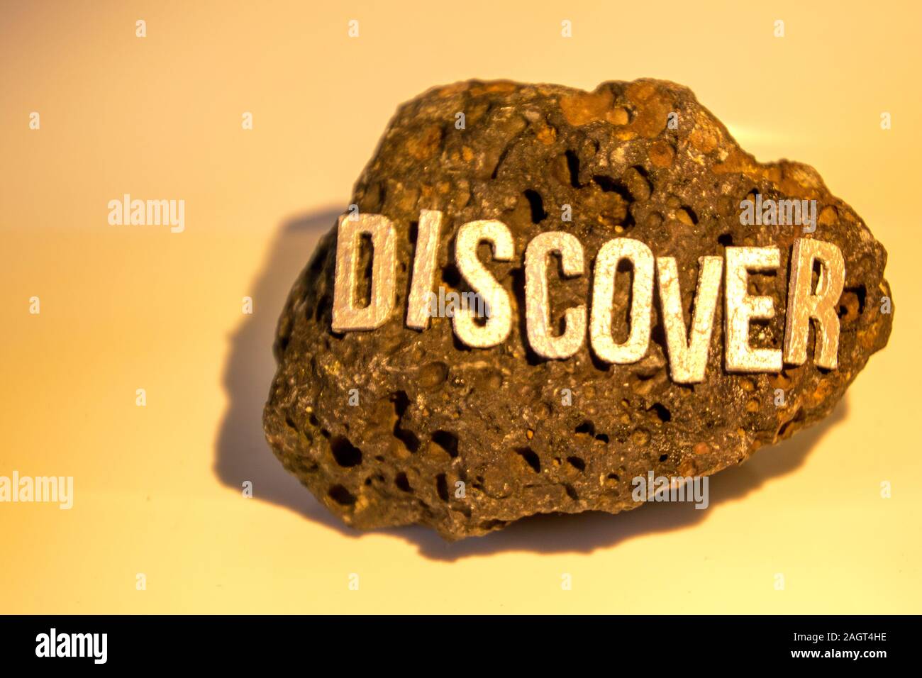 The word Discover on a rock surface to show the findings of any item ...