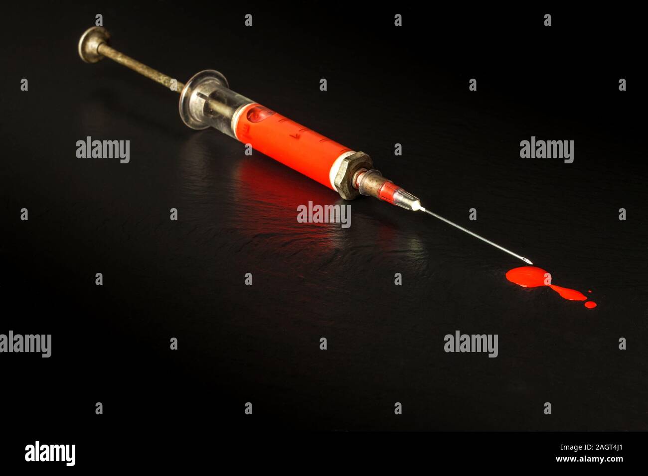 Syringe and blood on black background. Risk of HIV infection. Flu ...