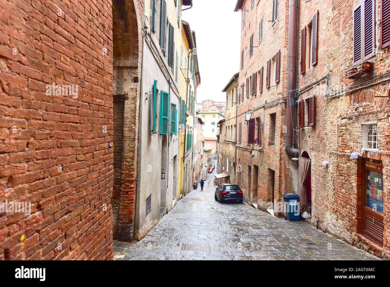 Alley with Brick Buildings in the Medieval Town of Siena, Italy Stock ...
