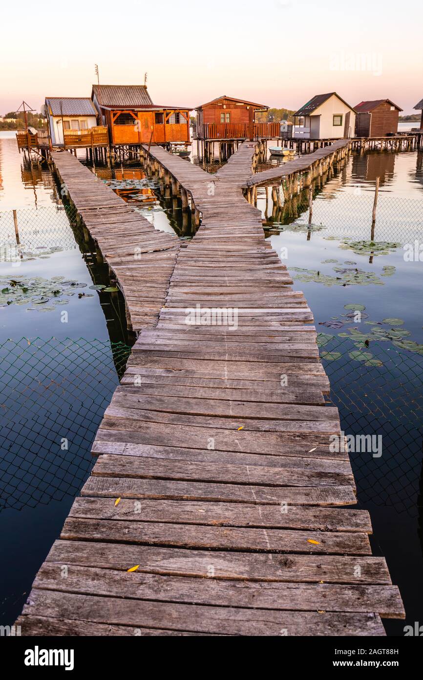 Floating village Bokodi in Hungary at sunrise. These houses belong to ...
