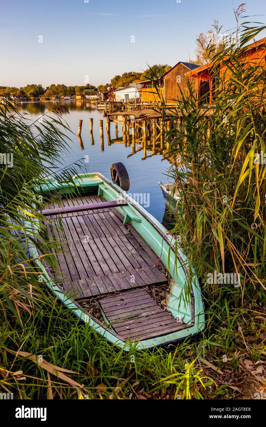Boats at floating village Bokodi in Hungary at sunrise. These houses ...