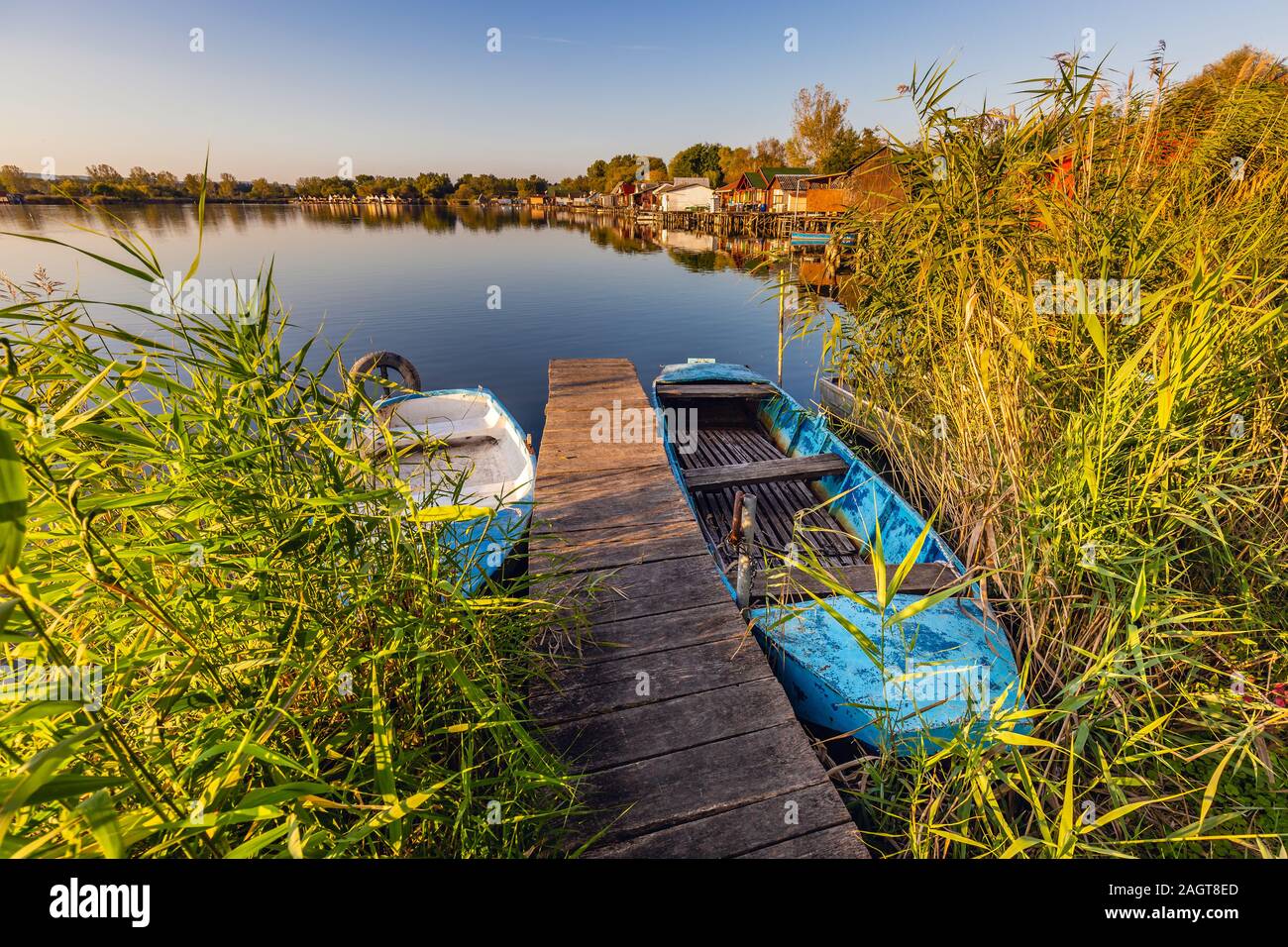 Boats at floating village Bokodi in Hungary at sunrise. These houses ...