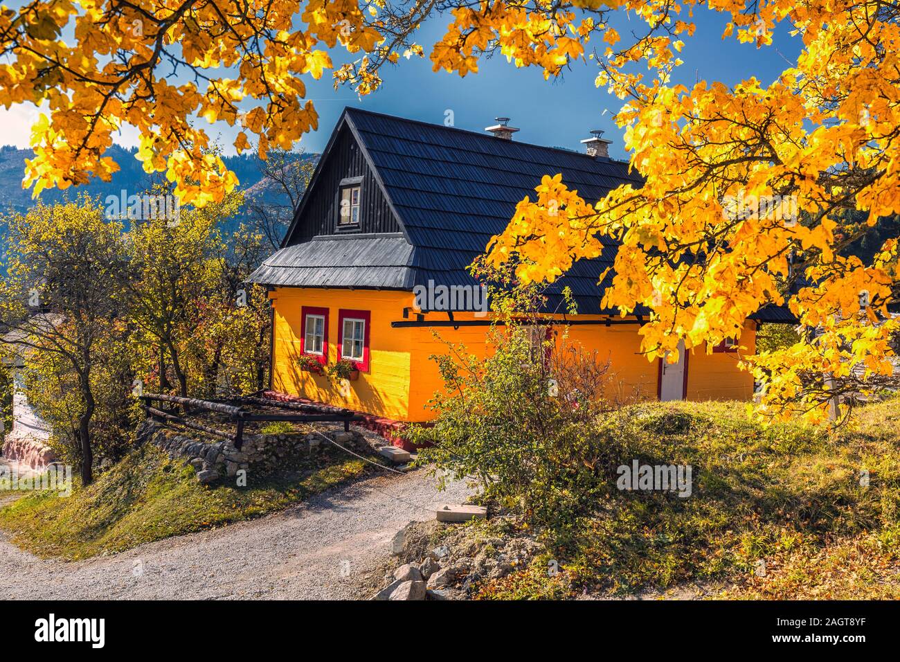 Yellow autumn leaves near house in Vlkolinec village in northern ...