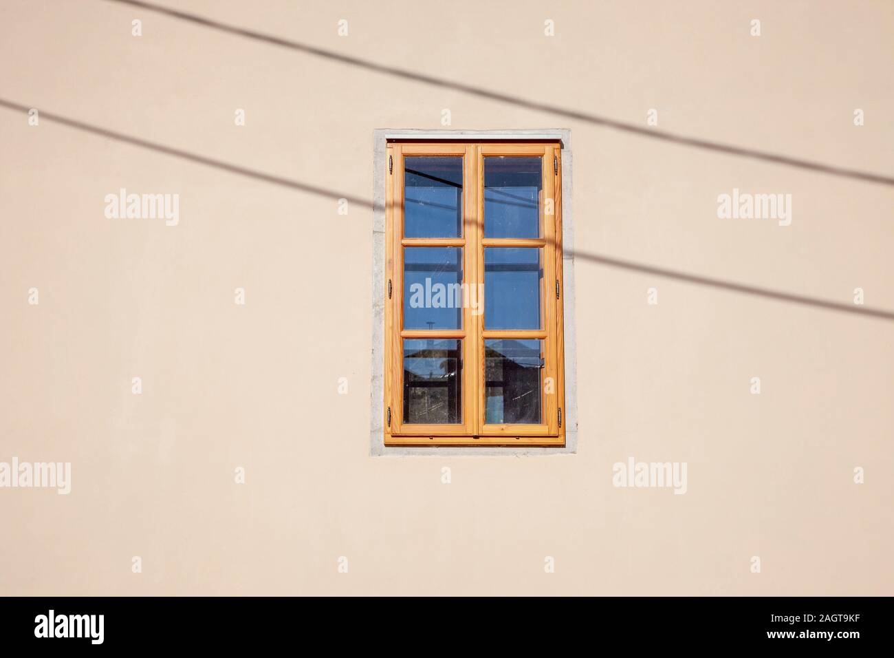 closed window in the middle of the beige wall. Through the wall and the ...