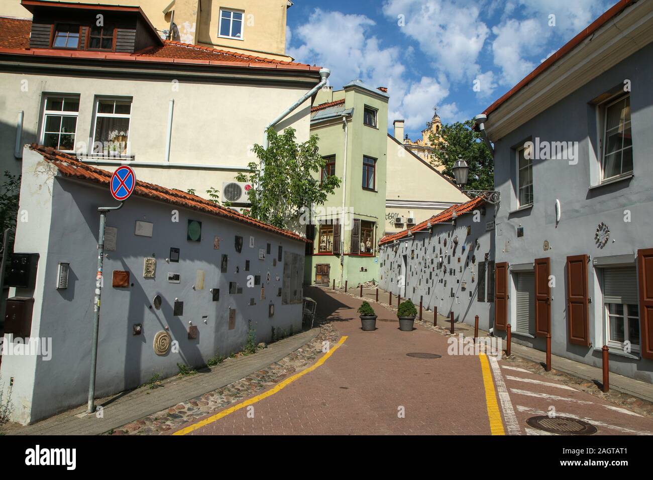 The small narrow street in Vilnius with some small artificial objects ...