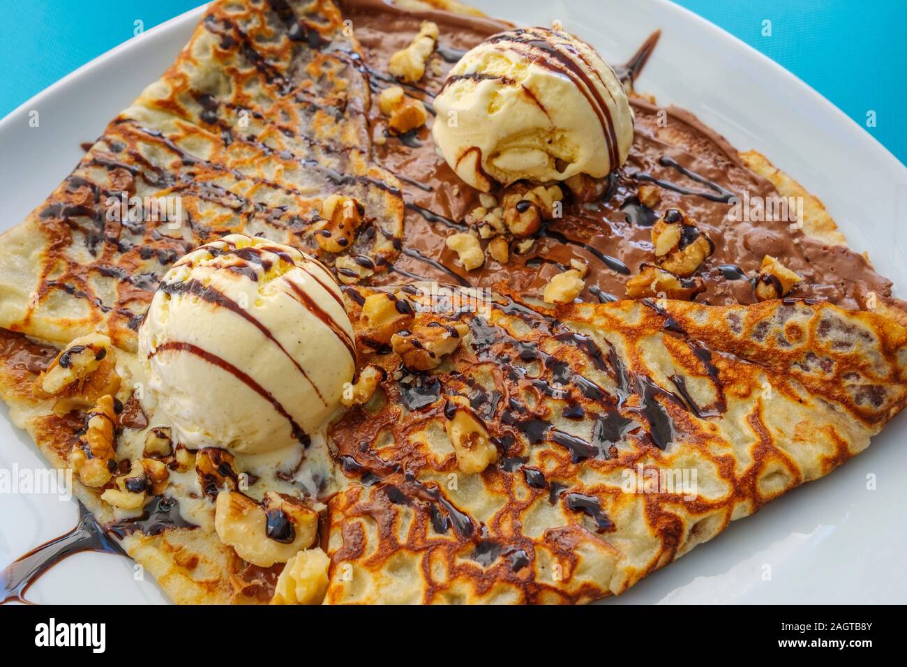 Homemade tasty crepes with vanilla ice cream, caramel and nuts Stock ...