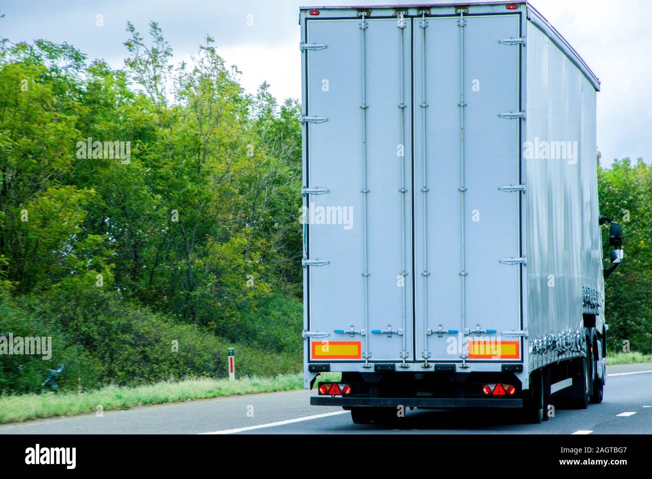 A lorry transporting goods of all sorts, traveling along a main UK ...