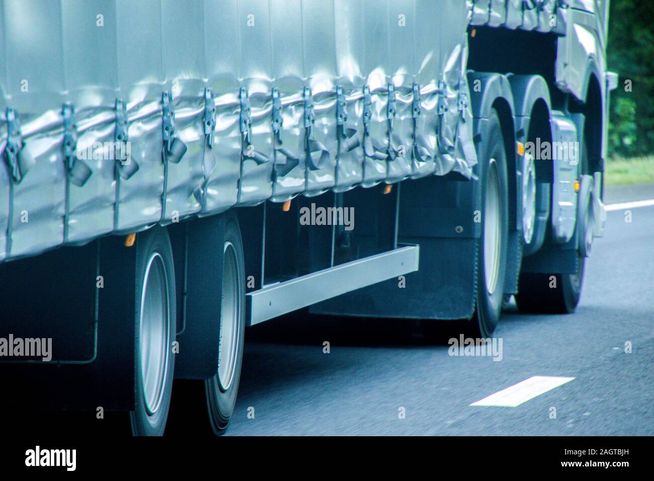 A lorry transporting goods of all sorts, traveling along a main UK ...