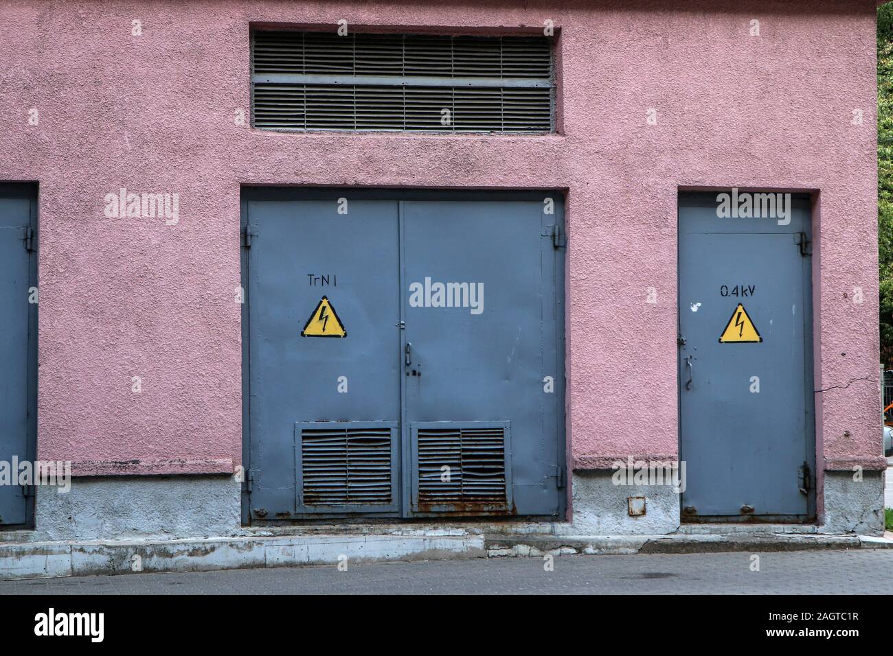The detail of the small transformer station with metal door and warning ...