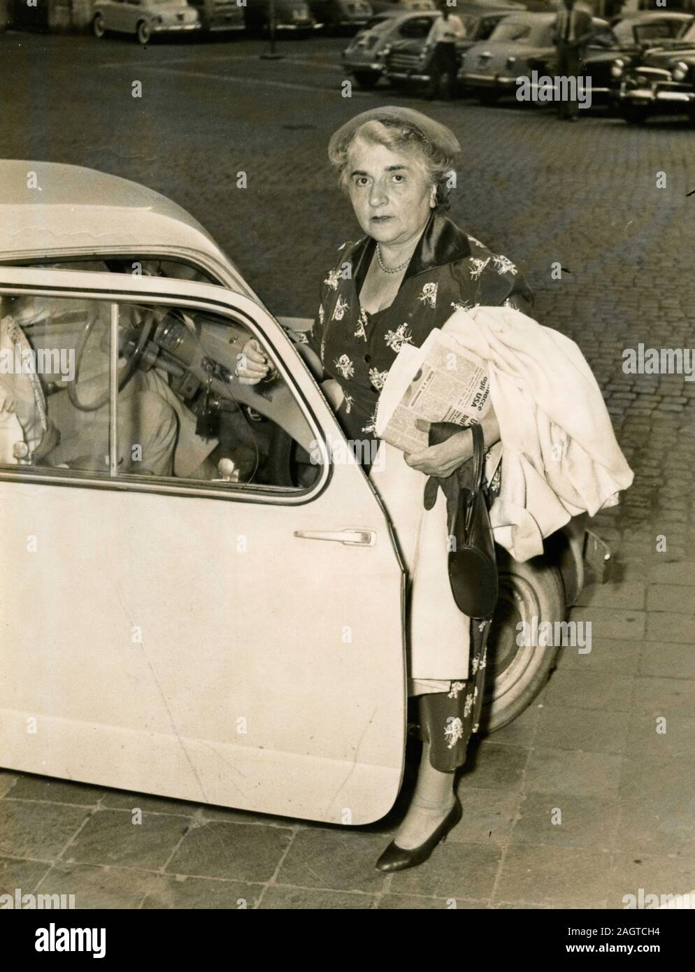 Italian teacher and politician Lina Merlin getting in the car, Rome ...