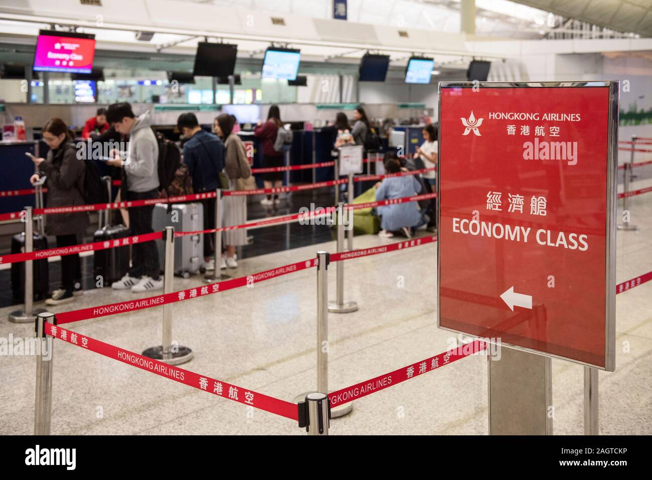 Flight passengers of Hong Kong Airlines are seen lining up at a check ...