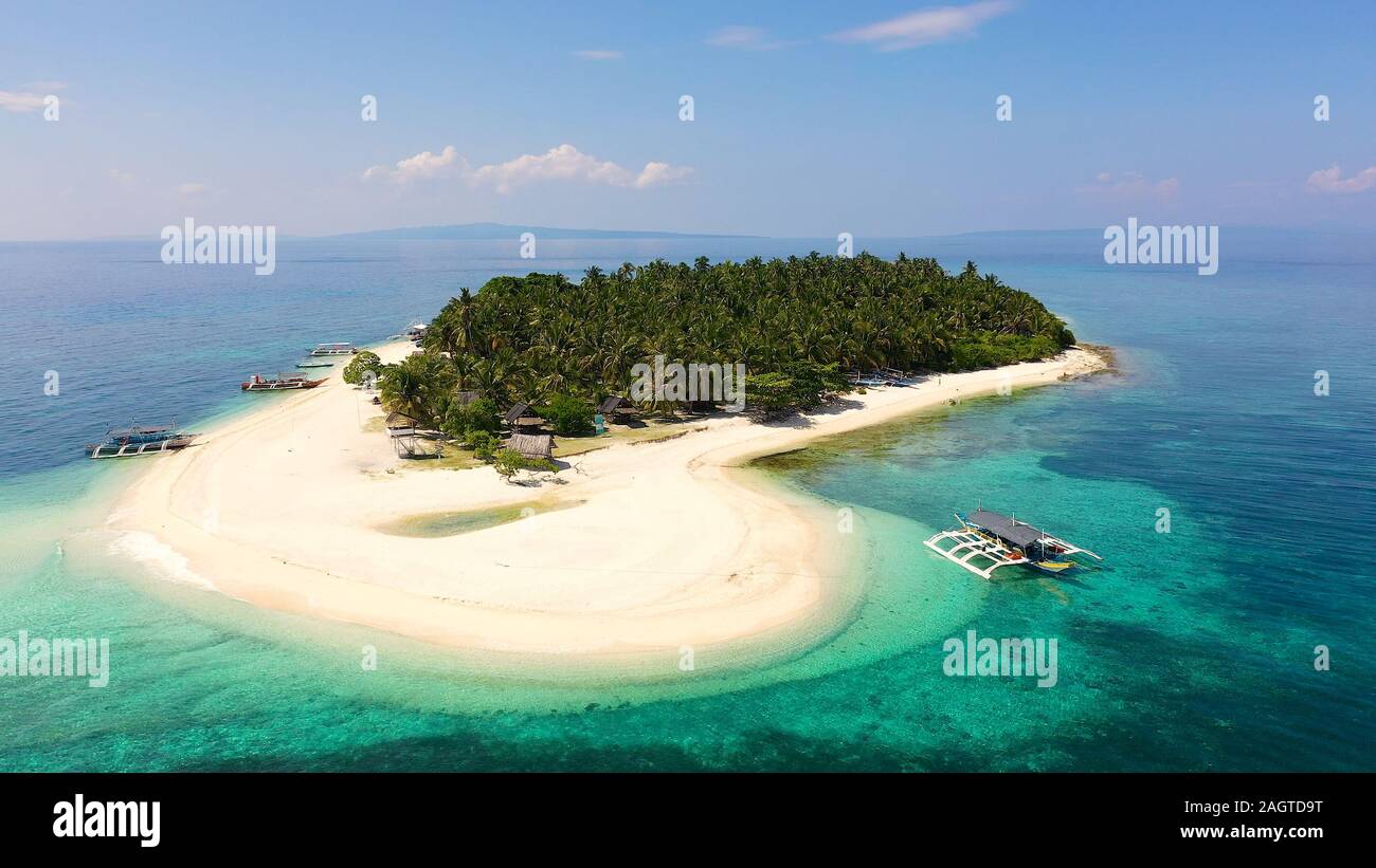 The island of white sand on a large atoll, view from above. Tropical ...