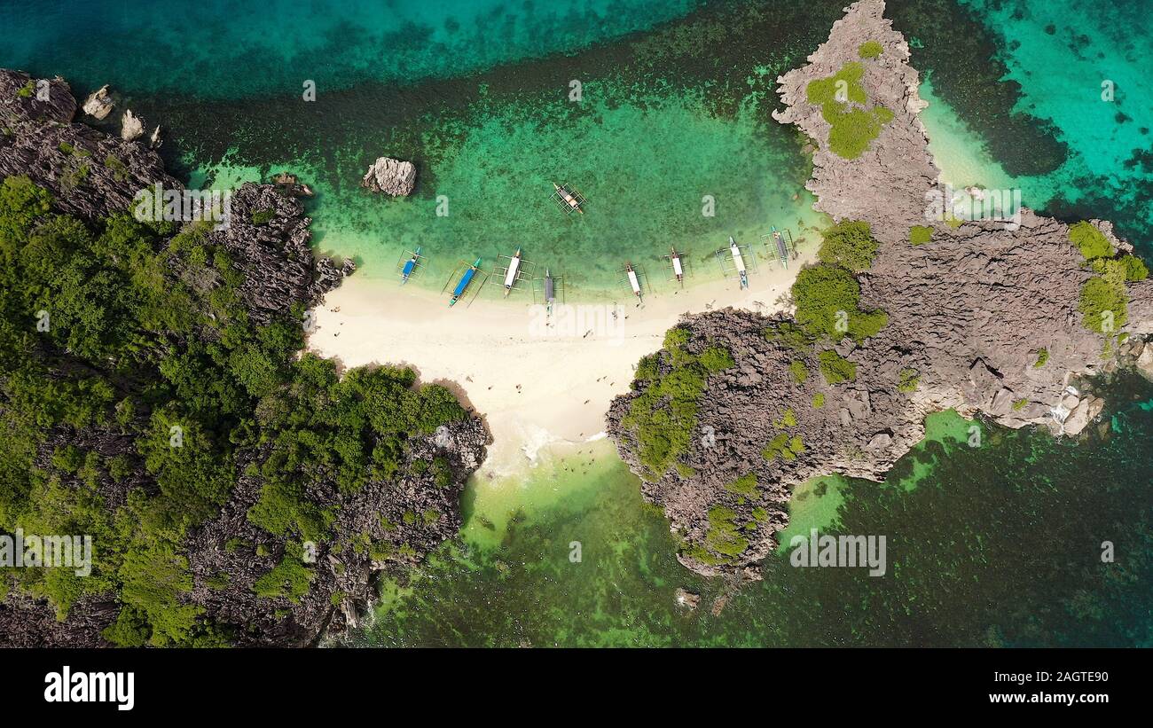 Tropical island with sandy with tourists and blue sea, aerial view ...