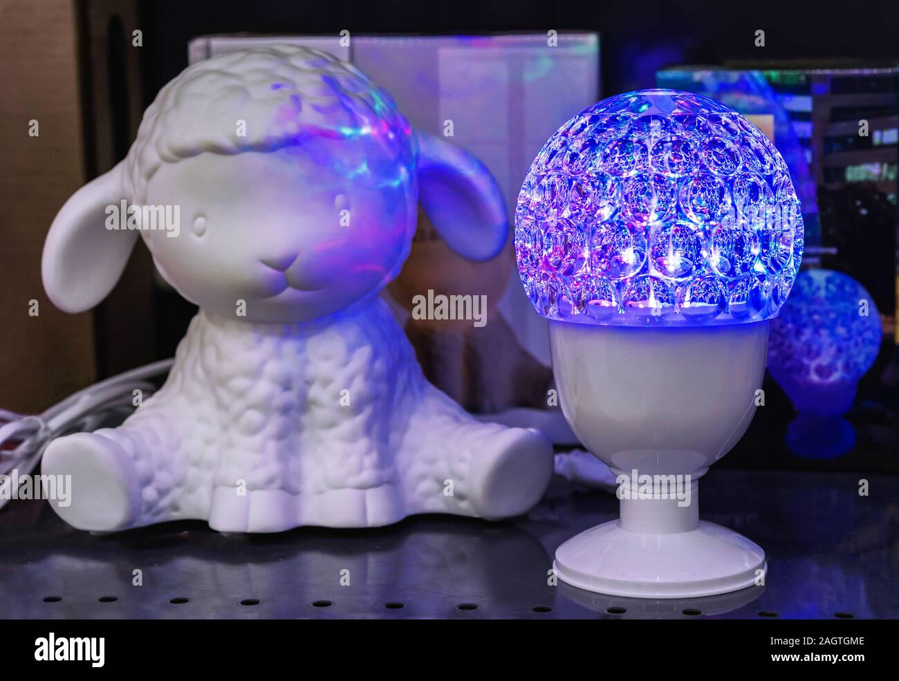 Blue LED lamp and a lamb figurine in the interior of a children's room ...