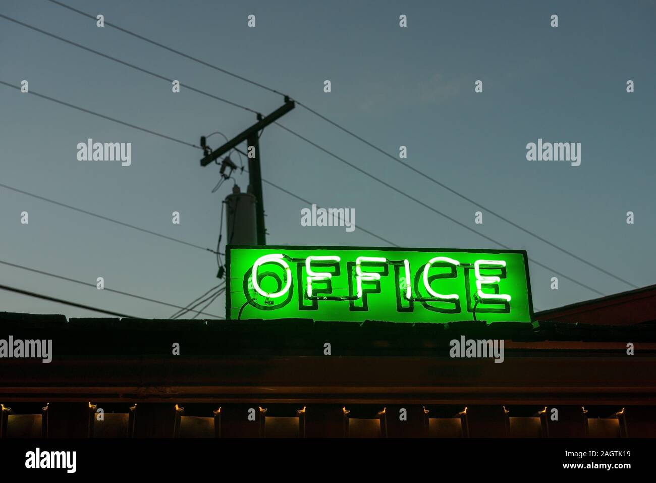 A Green Neon Office Sign at Night Stock Photo - Alamy