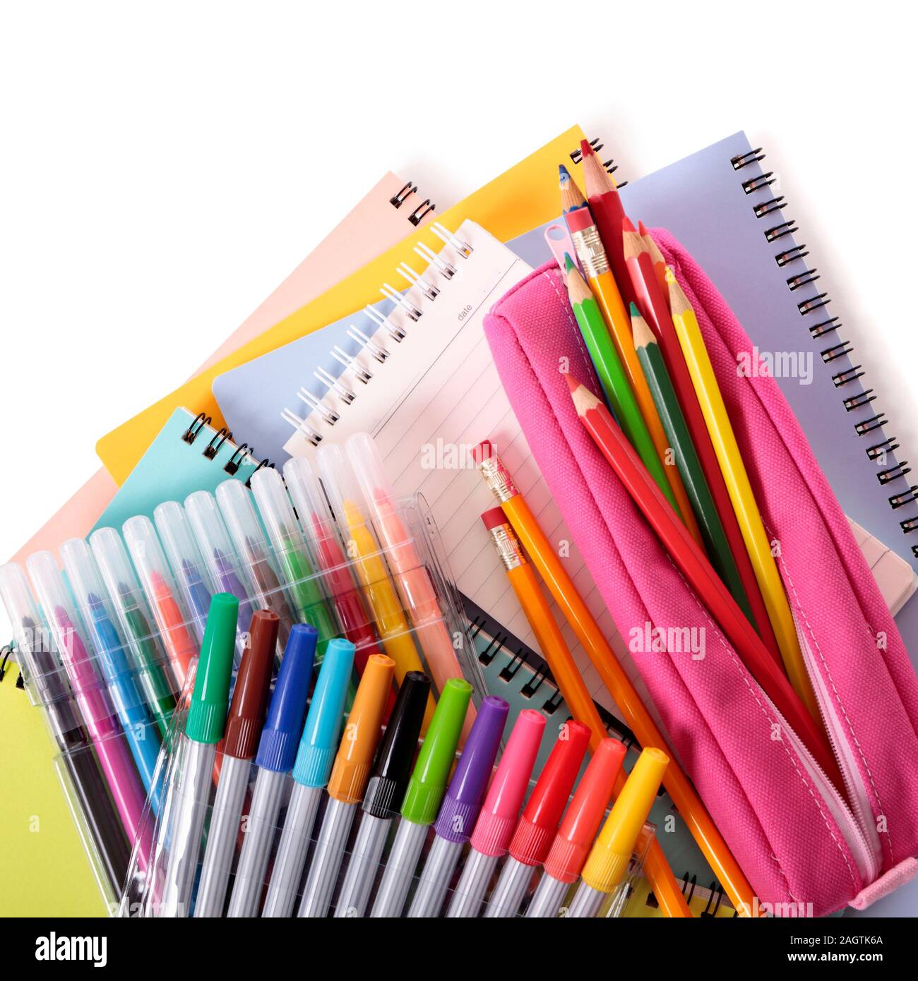 Various school supplies including notebooks and pink pencil case ...