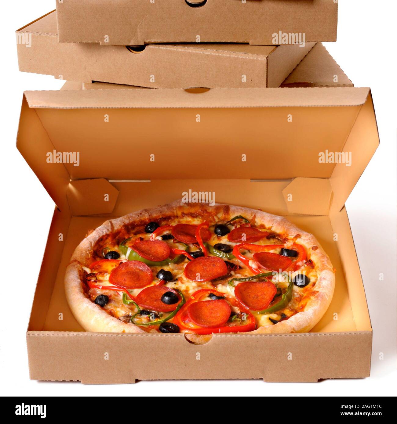 Freshly baked Italian pepperoni Pizza with a stack of delivery boxes ...