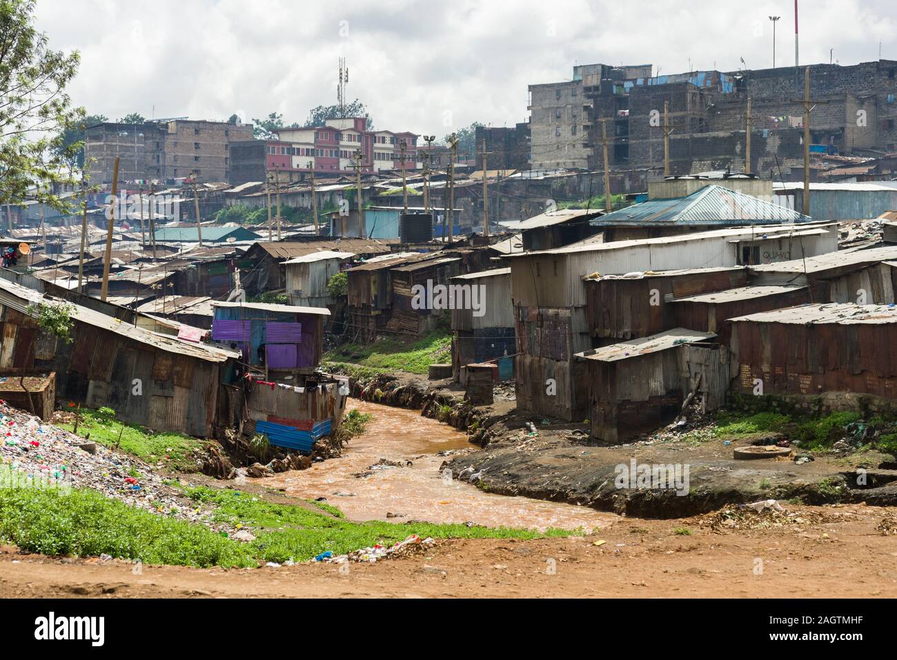 Mathare river with metal shacks lining it flowing through Mathare slum ...