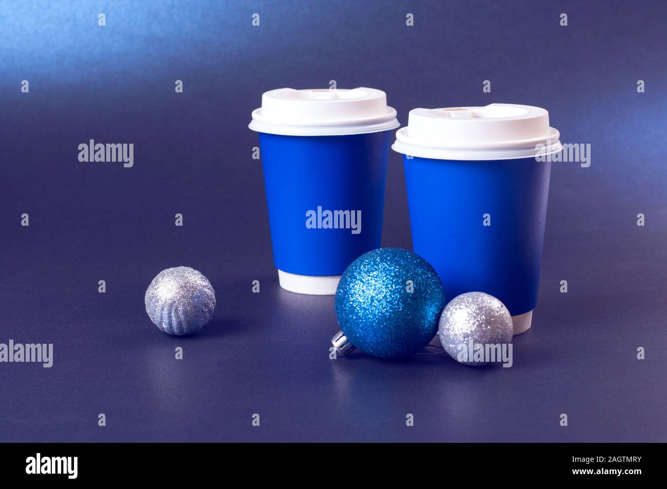 Blank blue to go coffee cups with Christmas decorations on trendy ...