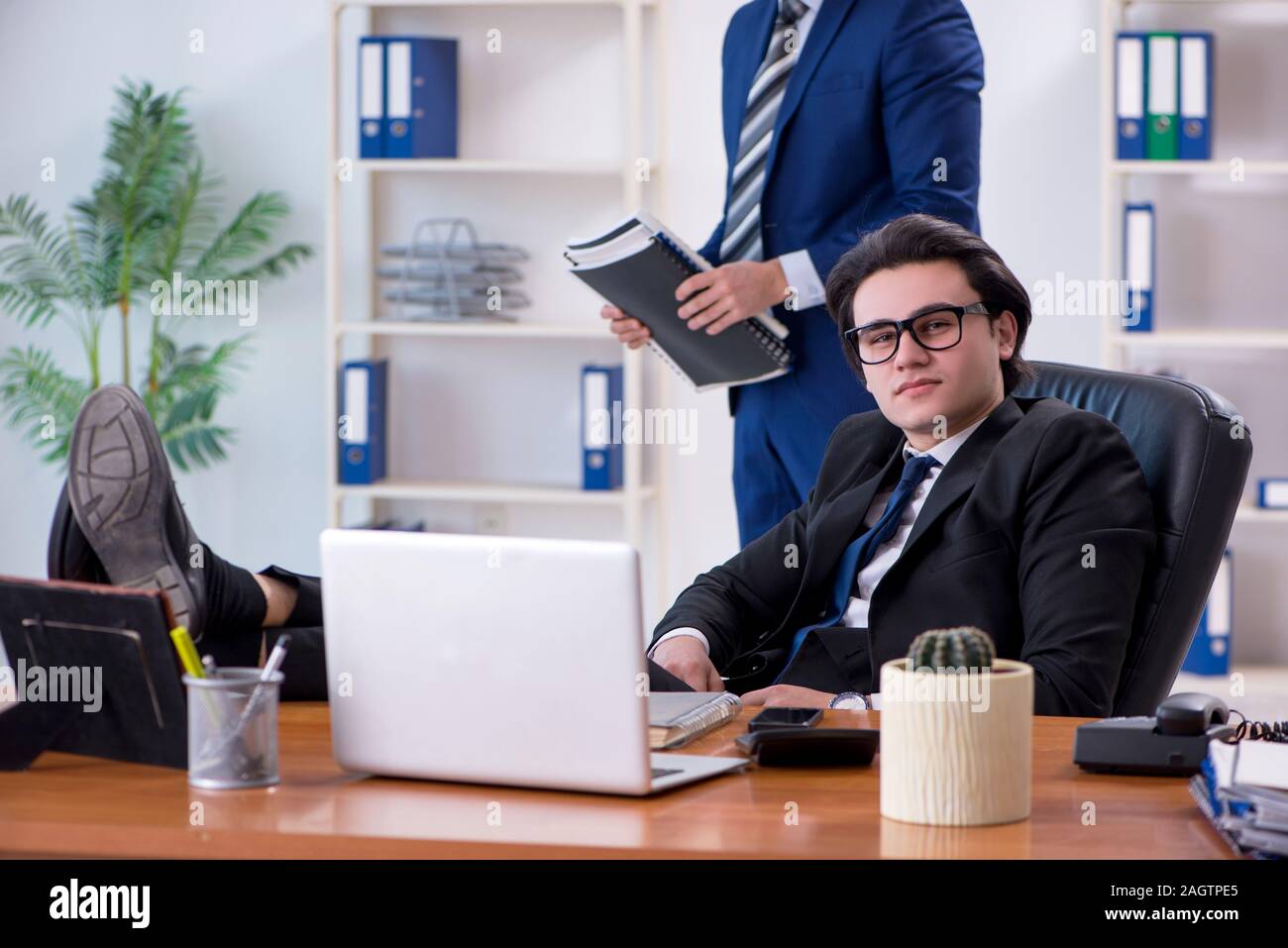 The boss and his male assistant working in the office Stock Photo - Alamy
