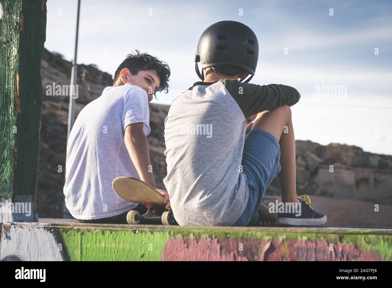 Two boys talking street hi-res stock photography and images - Alamy