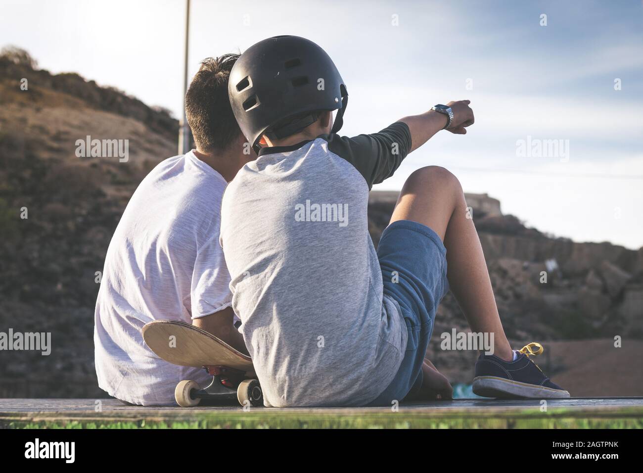 Two boys talking street hi-res stock photography and images - Alamy