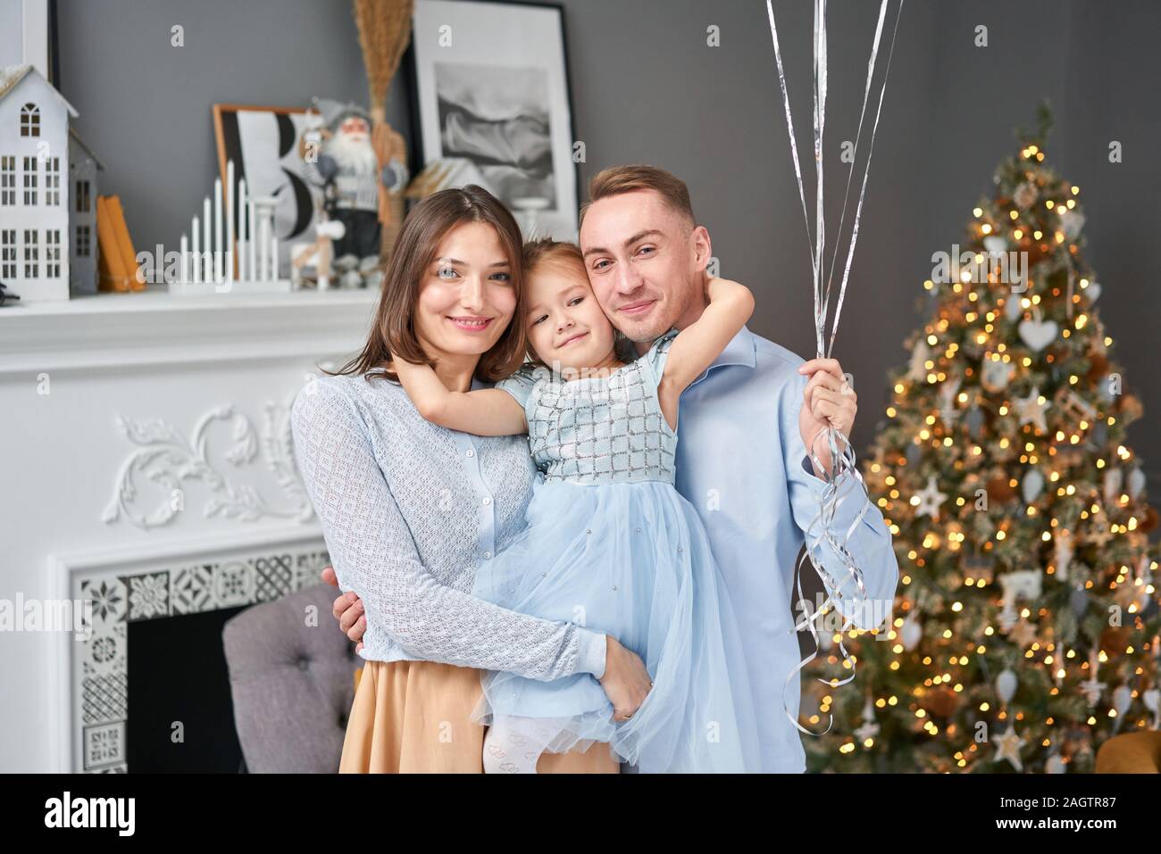 Loving family. Mom and dad hugging little daughter . Parents and baby child having fun near ...