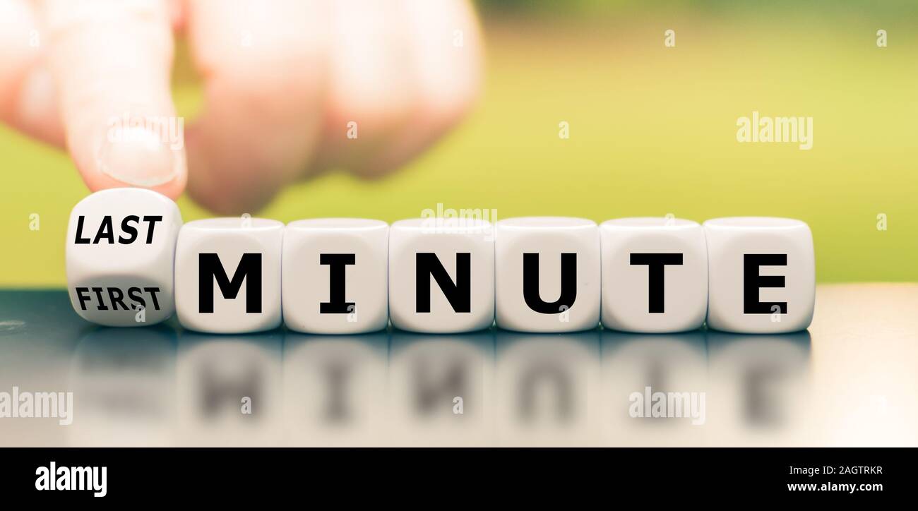 Hand turns a dice and changes the expression "first minute" to "last ...