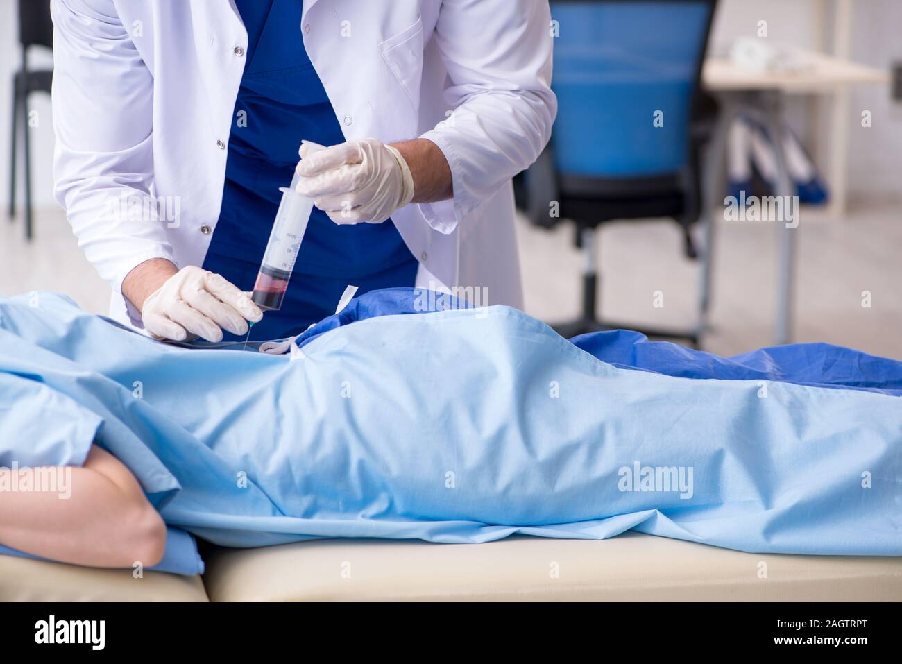 The female patient getting an injection in the clinic Stock Photo - Alamy