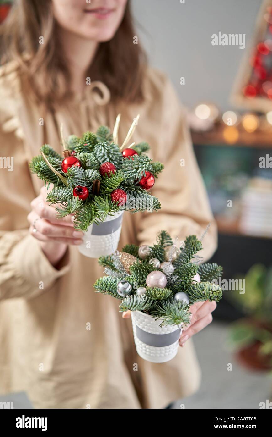 Two Beautiful festive arrangements of fresh spruce in coffee Cup ...