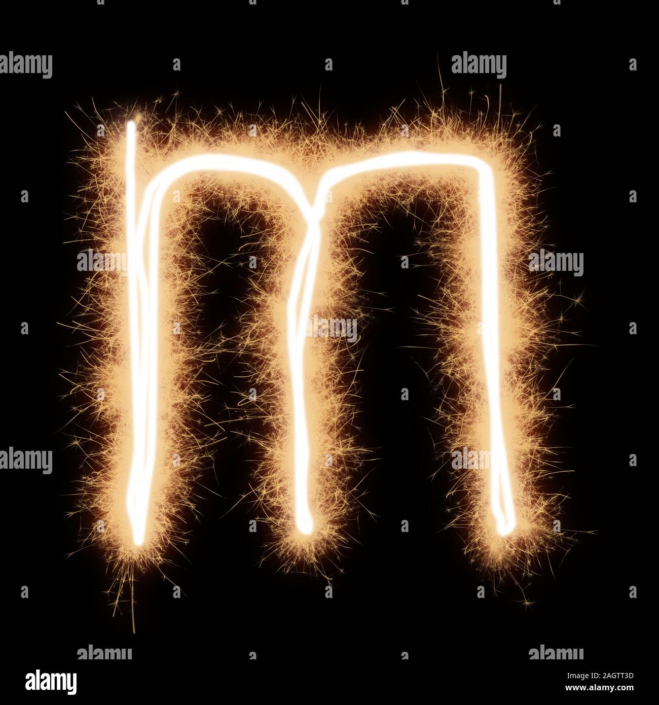 Lower case m letter of alphabet written by squib sparks on a black ...